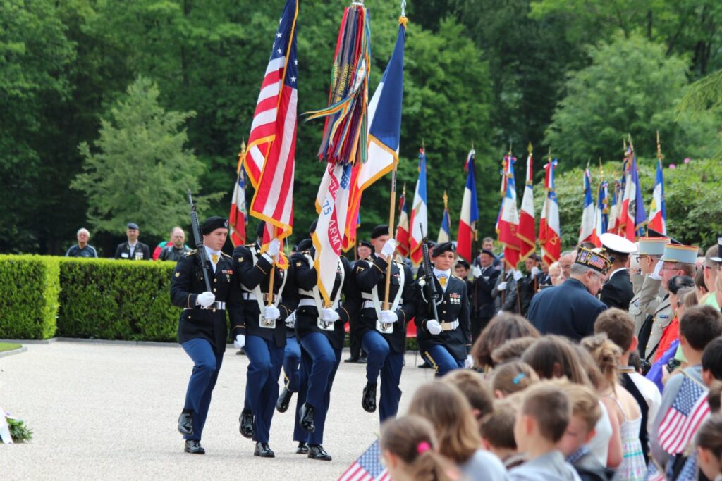 Members of the Color Guard march with flags and weapons. - American ...