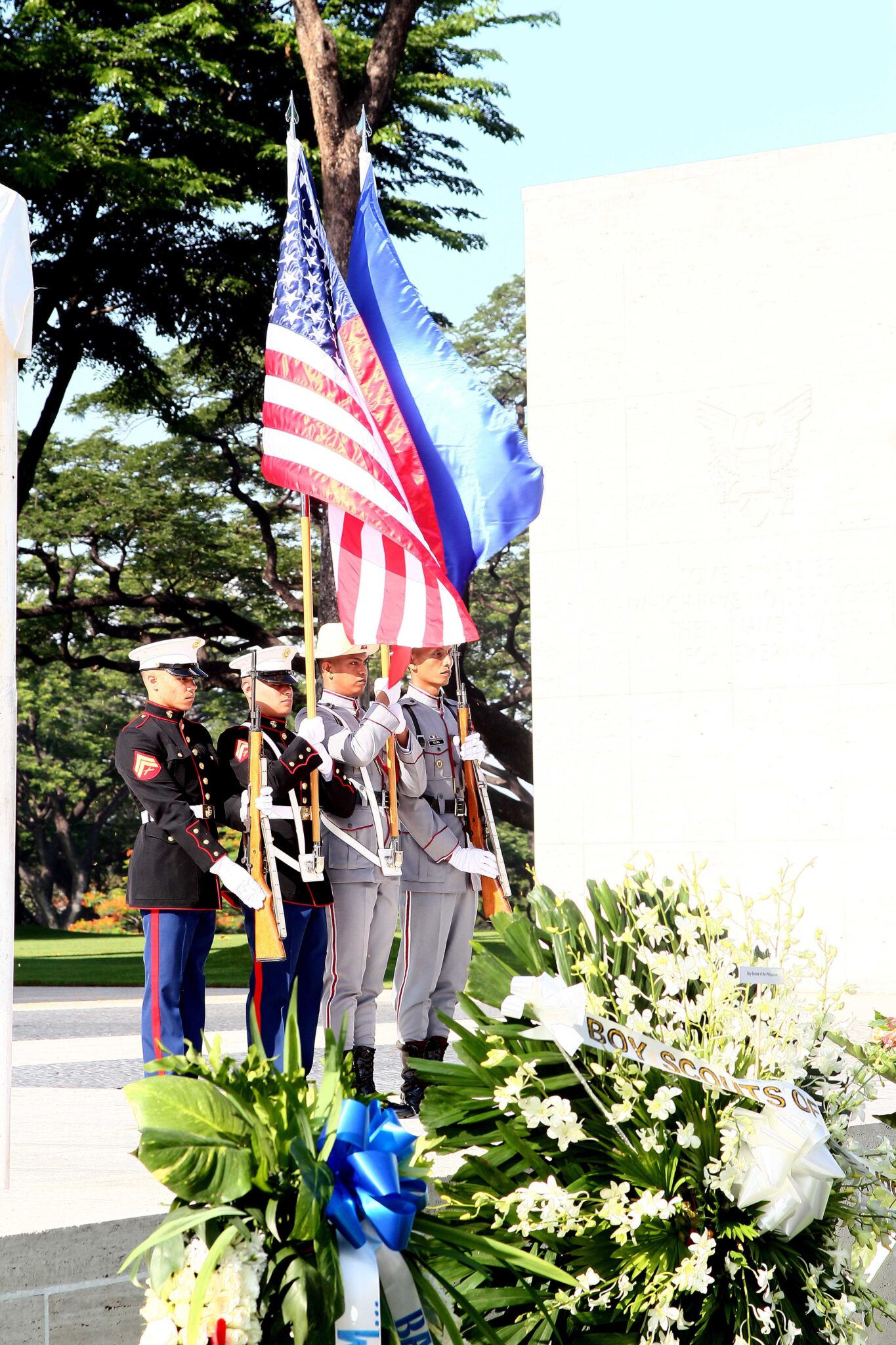Men in uniform stand with flags. - American Battle Monuments Commission ...