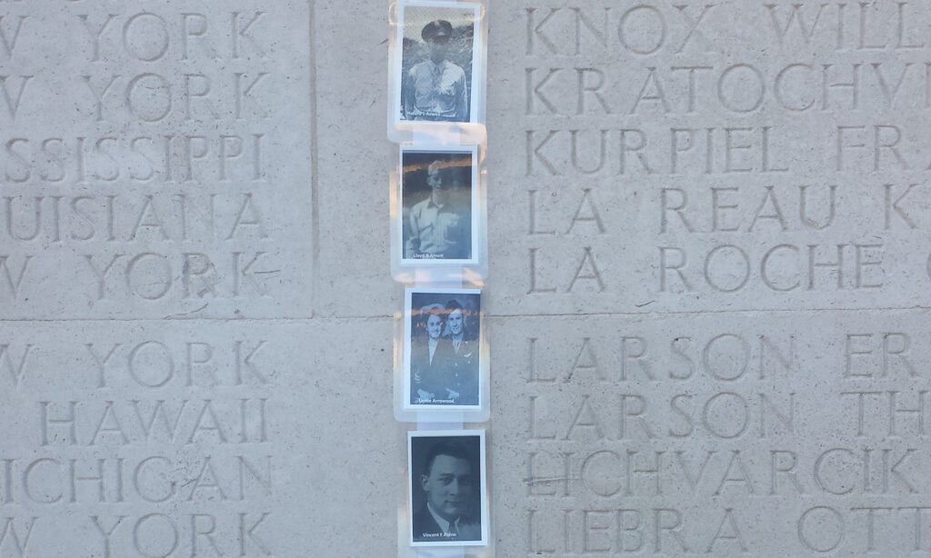 Black and white photos are attached to the Wall of the Missing ...