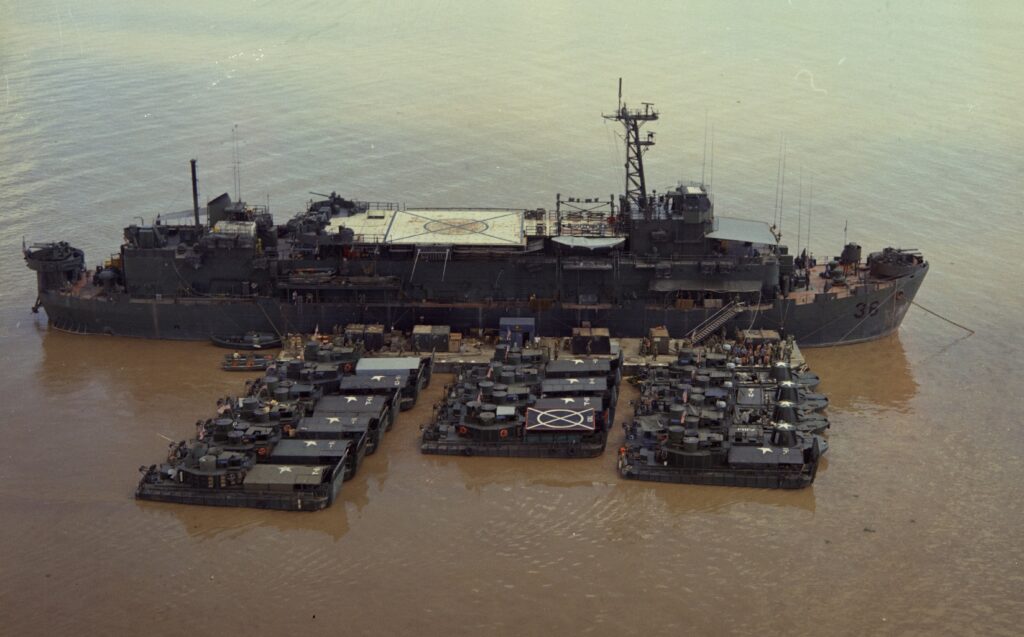 Large ship with floating pier and helipad next to grouping of 15 ...
